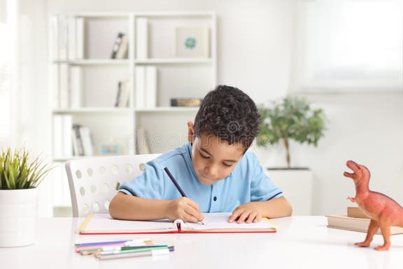 Cute Boy Writing Homework on a Desk Stock Photo - Image of childhood ...