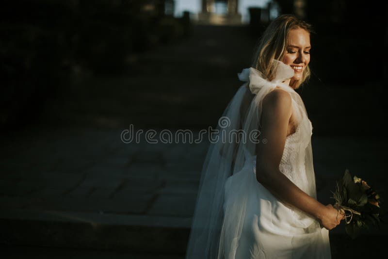 Cute Bride with Flower Bouquet Stock Photo - Image of wedding, flowers ...