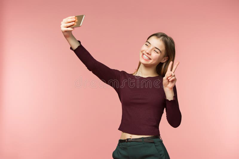 Cute Brunette Girl Takes A Selfie She Smiles Widely She Has Long Wavy Brunette Hair Beauty