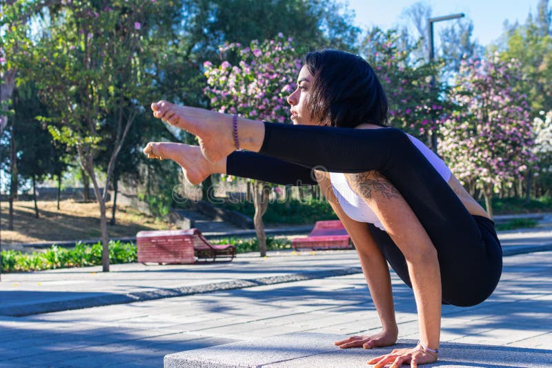 Cute Brunette Yoga Instructor Concentrating And Doing Tittibhasana