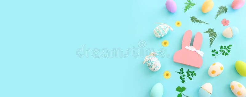 Cute Bunny Next To Easter Colorful Eggs Over Blue Pastel Background ...