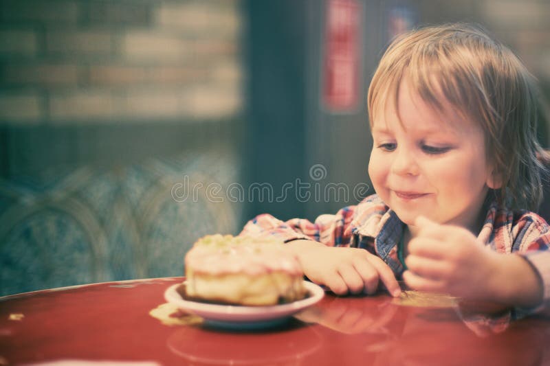 Cute Cheerful Blond Boy Sitting in Cafe with Piece of Cake Stock Photo ...