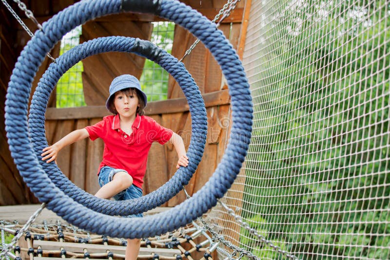 Cute Child, Boy, Climbing in a Rope Playground Structure Stock Image ...