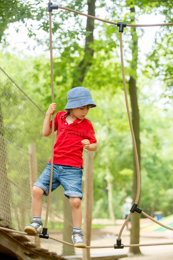 Cute Child, Boy, Climbing in a Rope Playground Structure Stock Image ...