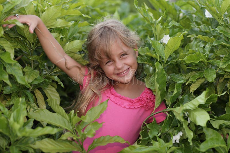 Cute child in the bushes stock photo. Image of wellness - 16659660