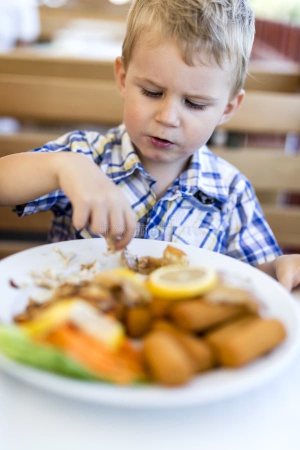 Cute child eating alone stock photo. Image of restaurant - 62442348