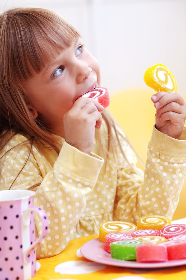 Cute child eating candies stock photo. Image of adorable - 15867430
