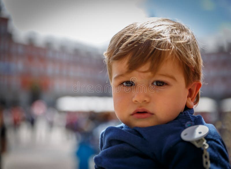 A Cute Child Looks Seriously Towards the Front Stock Photo - Image of ...