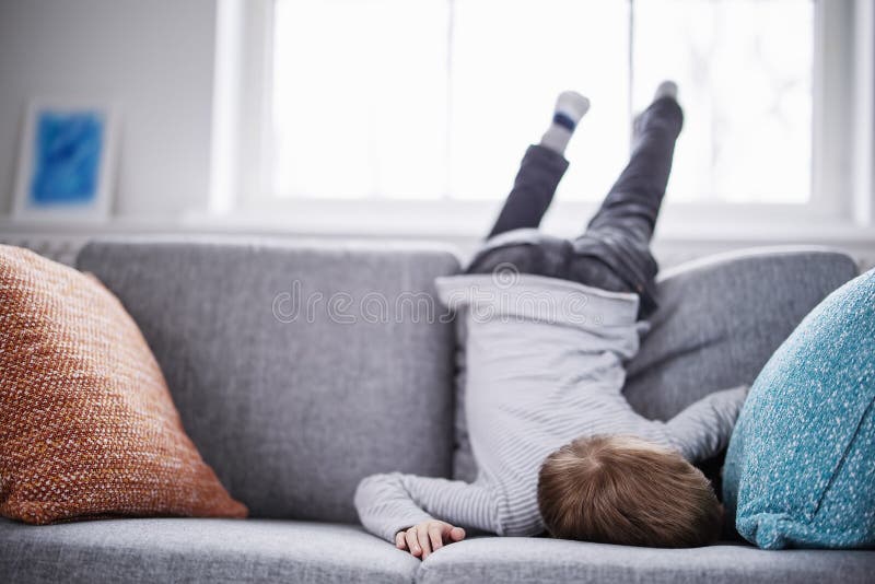 Cute Child Lying Face Down on the Sofa Stock Photo - Image of person ...