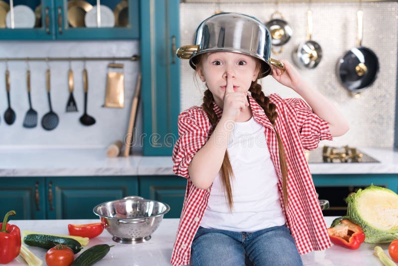 Cute Child with Pan on Head Looking at Camera and Gesturing Stock Photo ...