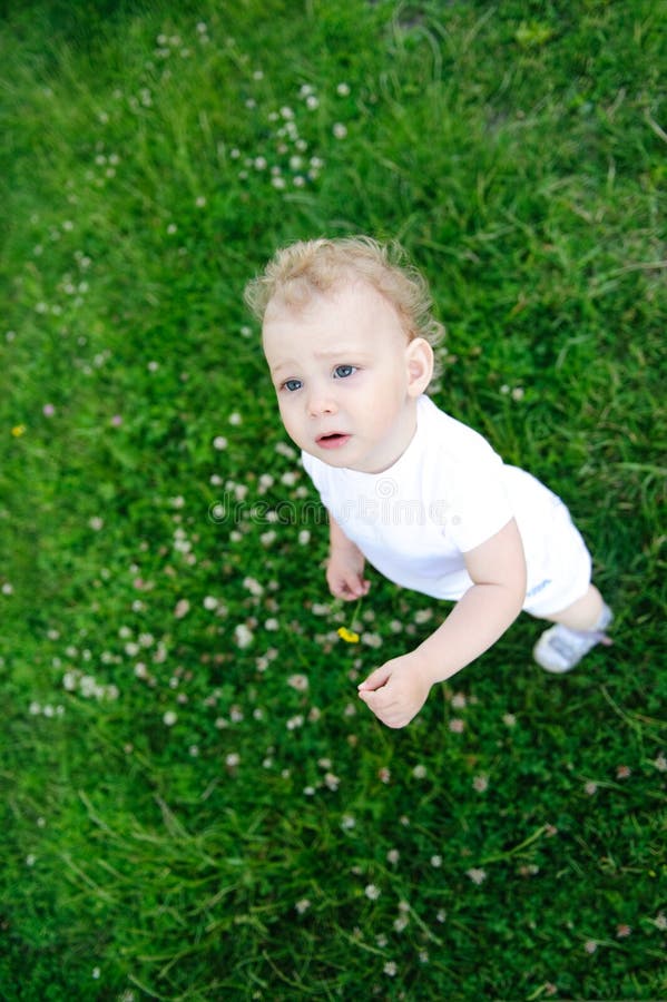 Cute Child Playing in Green Grass Stock Image - Image of head, cheerful ...