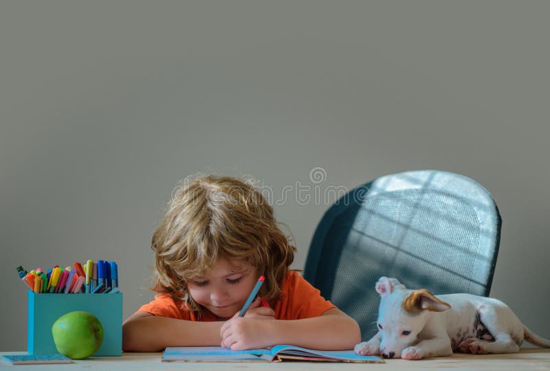 Cute Child with a Puppy Dog Studies and Learn at Home in Classroom ...