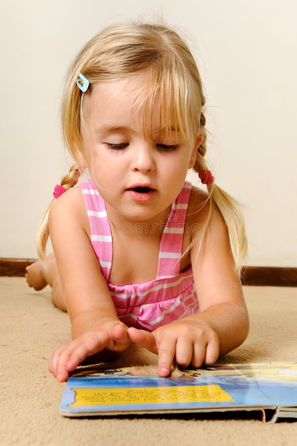 Cute child reading stock image. Image of floor, blonde - 18402429