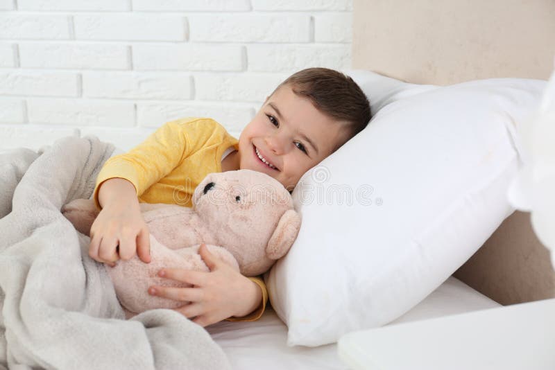 Cute child resting in bed stock image. Image of patient - 142365867