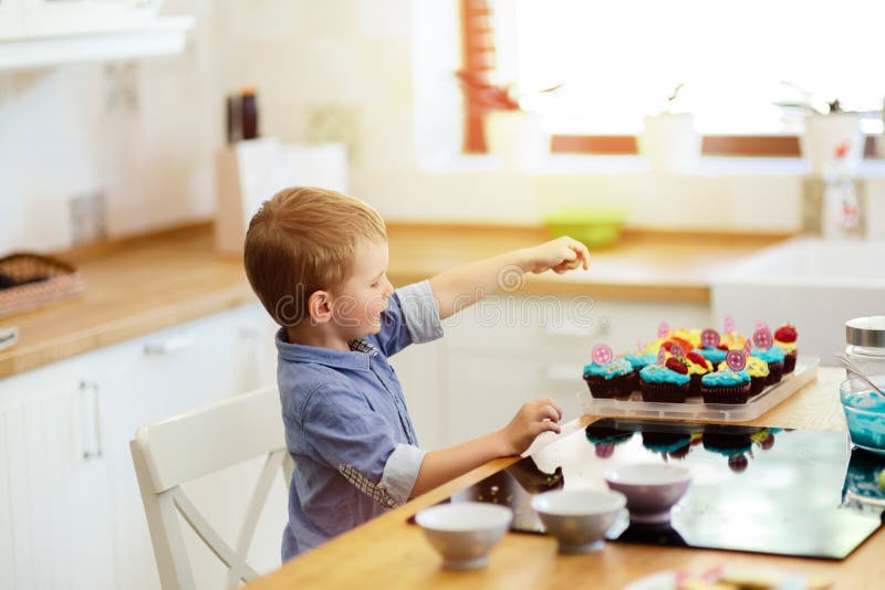 Cute child tasting cookies stock image. Image of chef - 132249383