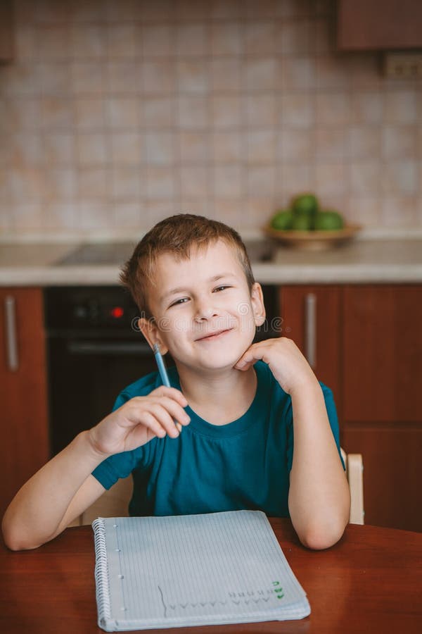 Cute Child Writing Letters in Notebook Sitting by Table Stock Image ...