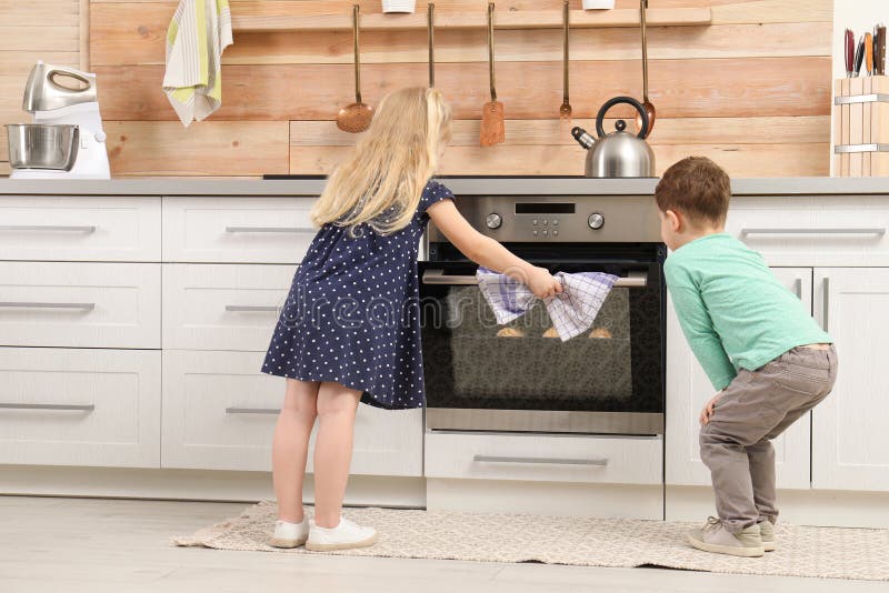 Cute Children Baking Cookies in Oven Stock Photo - Image of door, home ...