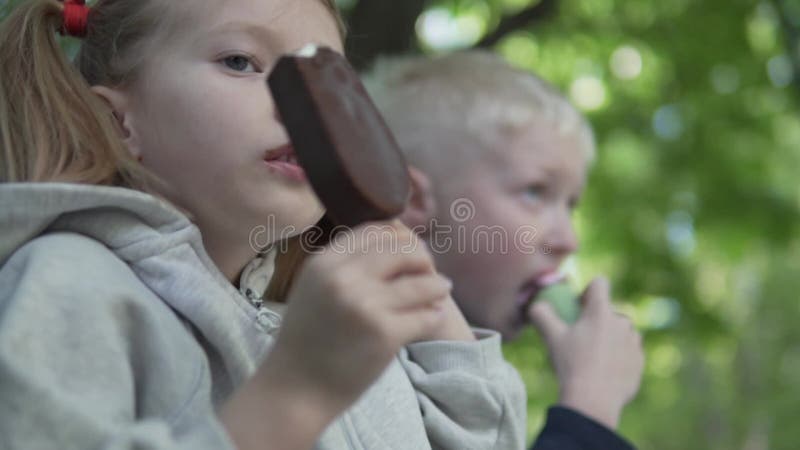 Cute Brother And Sister Eat Ice Cream In The Woods During The