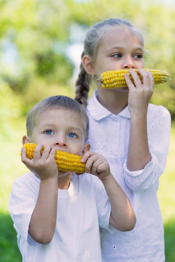 Cute Children Eating Corn Outdoors Stock Photo - Image of eating, happy ...