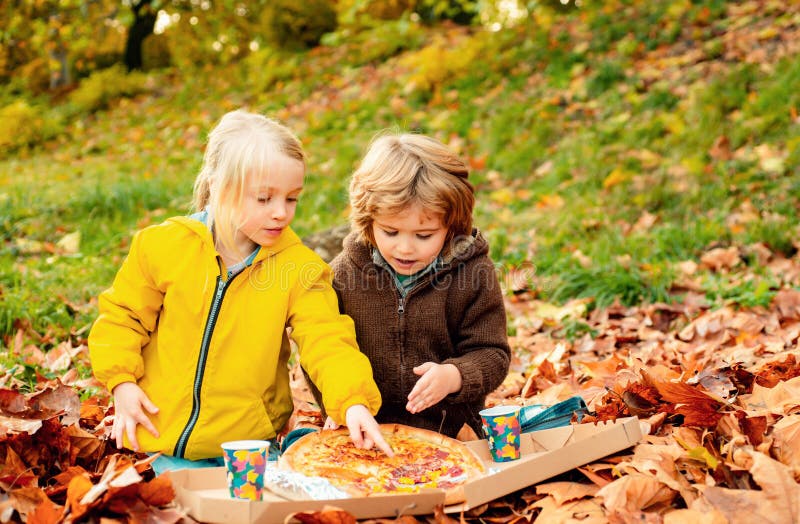 Cute Children Eating Pizza in Autumn Park. Stock Image - Image of pizza ...