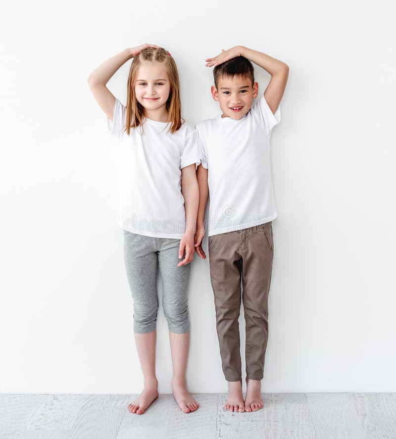Cute Children Measuring and Comparing Height Stock Photo - Image of ...