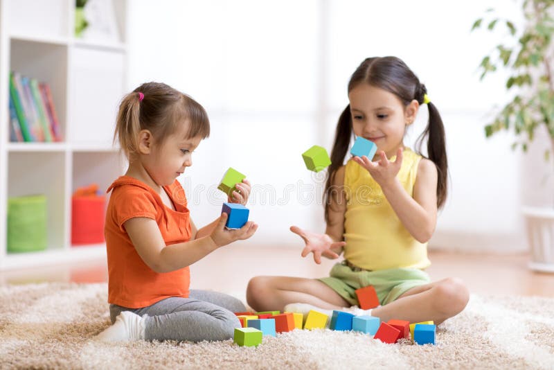 Cute Children Playing while Sitting on Carpet at Home Stock Image ...