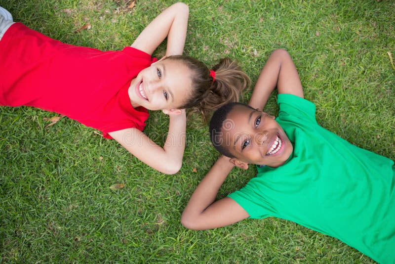 Cute Children Smiling at Camera Outside on the Grass Stock Image ...