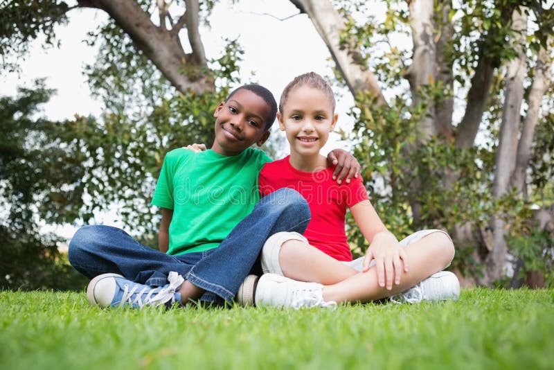 Cute Children Smiling at Camera Outside on the Grass Stock Photo ...