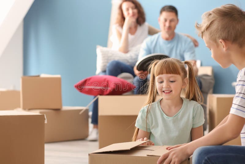 Cute Children Unpacking Box after Moving into New House Stock Photo ...