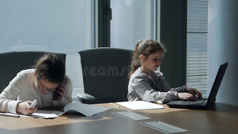 Cute Children Work in a Modern Office with Documents and a Laptop Stock ...