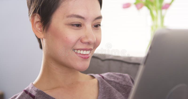 Cute Chinese Woman Happily Using Tablet Stock Video - Video of tablet ...