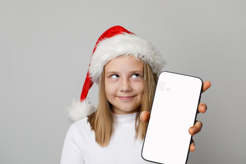 Cute Christmas Kid Santa Hat Looking Up Holding Smartphone with Blank ...