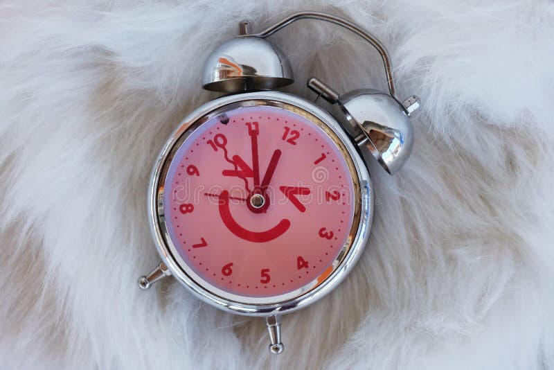 Cute clock on white fur. stock photo. Image of cute, time - 48340858