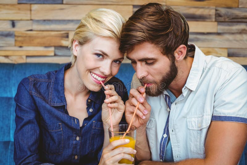 Cute Couple on a Date Sharing a Glass of Orange Juice Stock Photo ...