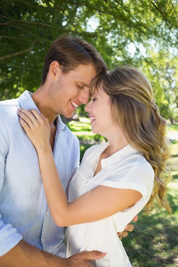 Cute Couple Hugging In The Park And Smiling At Each Other Stock Image ...