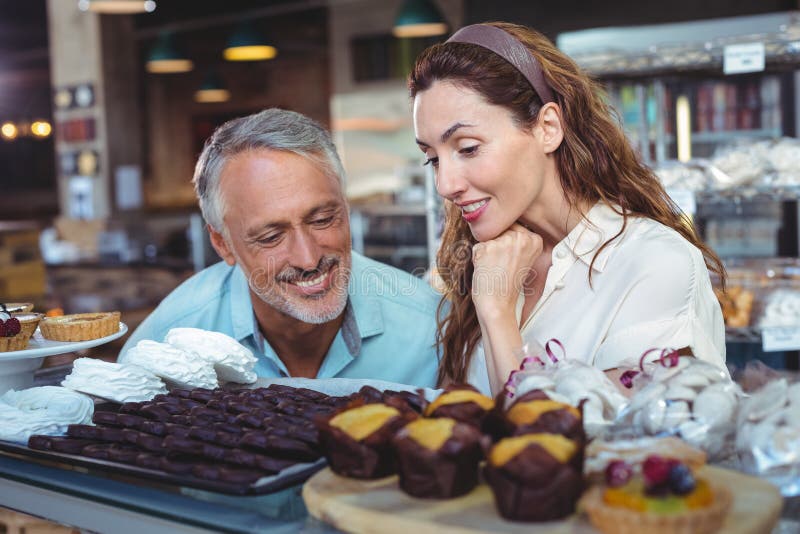 Cute Couple Looking at Cakes Stock Photo - Image of long, brown: 56487102