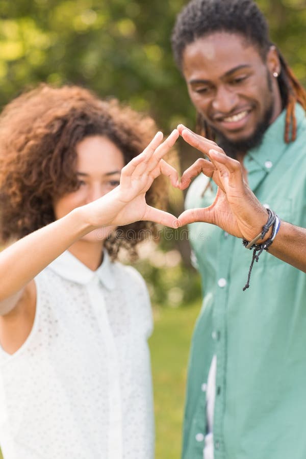 Cute Couple in the Park Making Heart Shape Stock Photo - Image of ...