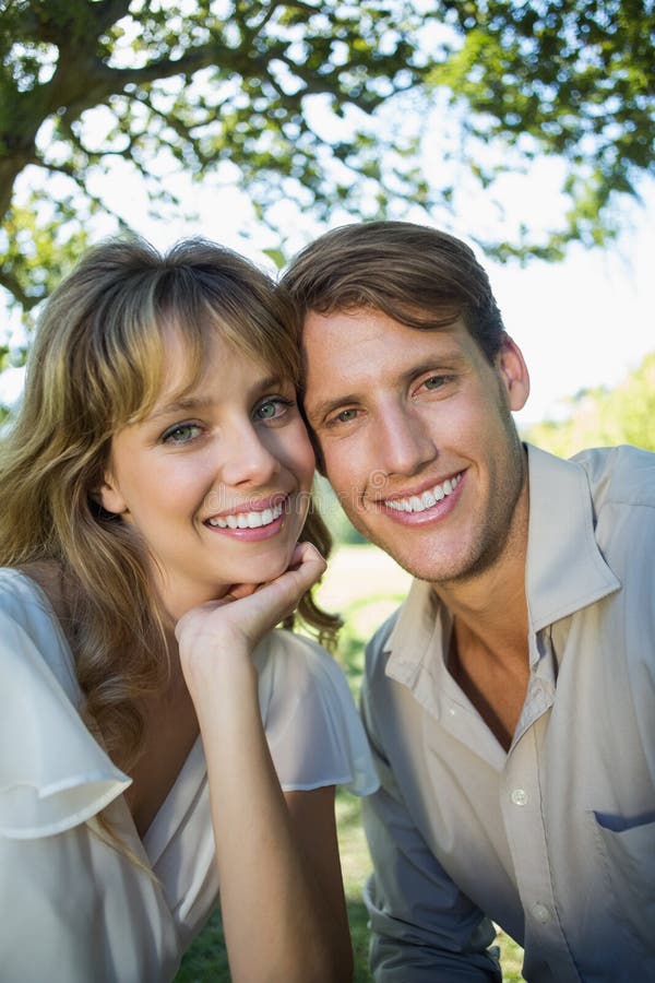 Cute Couple Sitting Outside at a Cafe Smiling at Camera Stock Image ...