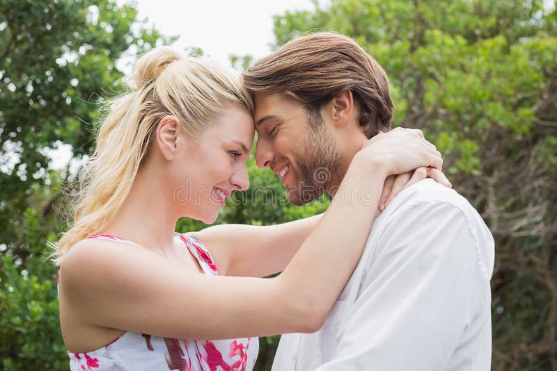 Cute Couple Standing Outside Hugging Stock Photo - Image of outdoors ...