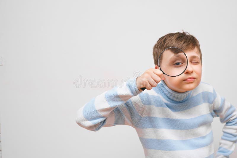 Curious Boy Looking Intently through Magnifying Glass on White B Stock ... Curious Boy Looking Intently through Magnifying Glass on White B Stock ...