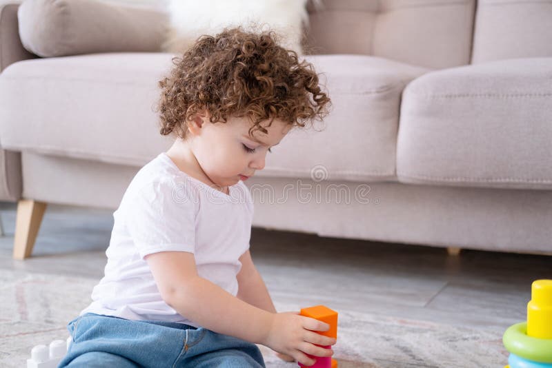 Curly Child Girl Playing with Pyramid and Constructor at Home. Early ...