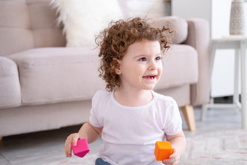 Cute Curly Child Girl Playing with Constructor at Home. Early Children ...