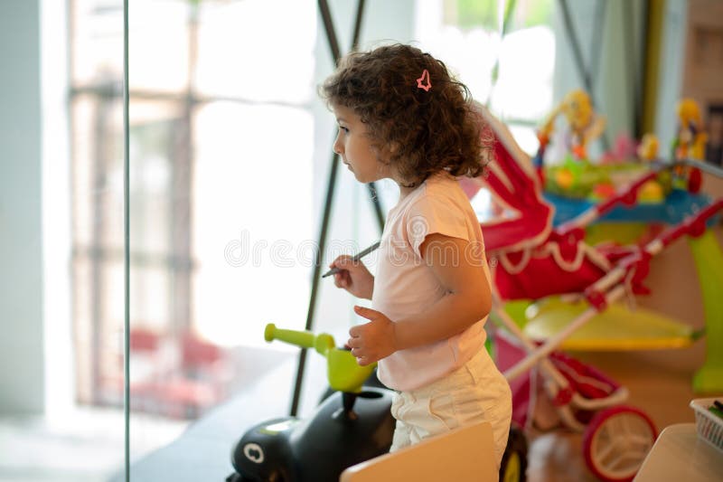 Cute Dark-haired Little Gitl Playing in a Play Room Stock Photo - Image ...