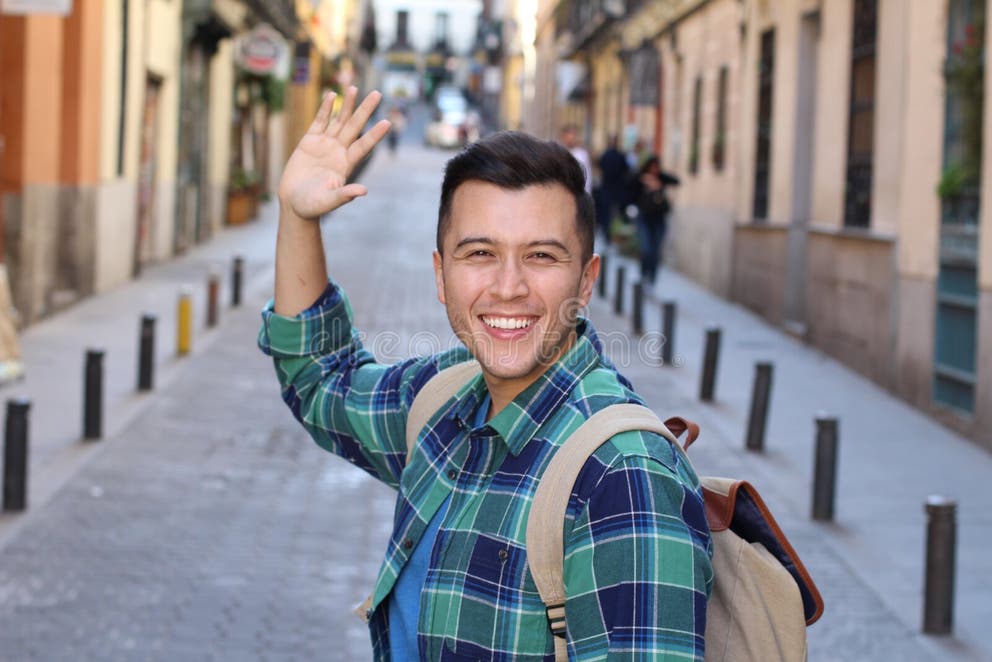 Cute Ethnic Guy Saluting Outdoors Stock Photo - Image of goodbye ...