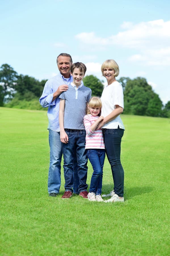 Cute Family of Four Posing To Camera Stock Photo - Image of child ...