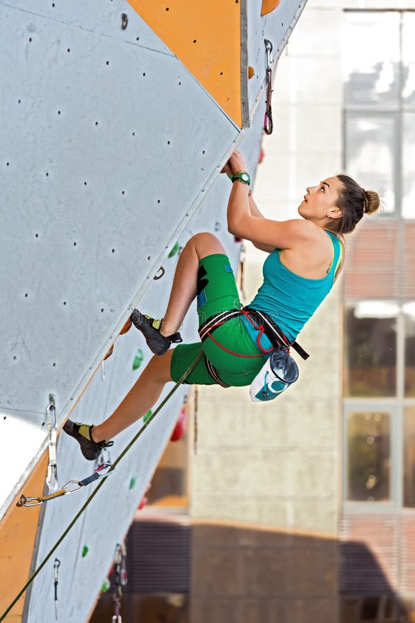 Cute Female Athlete Hanging on Climbing Wall Stock Photo - Image of ...