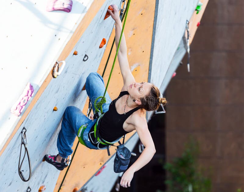Cute Female Athlete Hanging on Climbing Wall Stock Photo - Image of ...