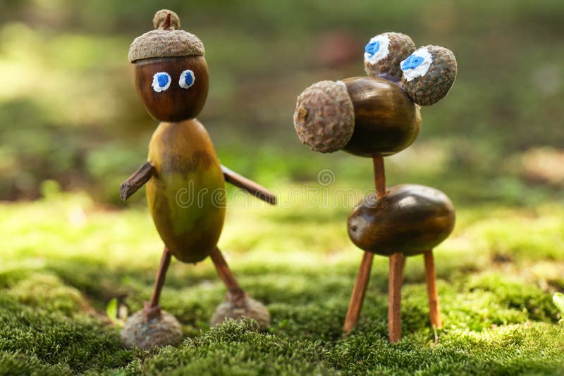 Cute Figures Made of Acorns on Green Moss Outdoors, Closeup Stock Photo ...