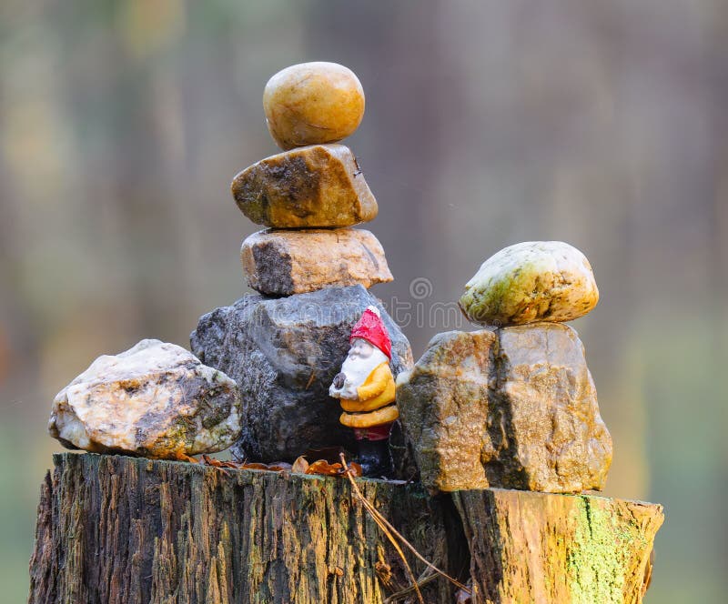 Cute Figurine on a Log with Rocks Stock Photo - Image of natural, life ...