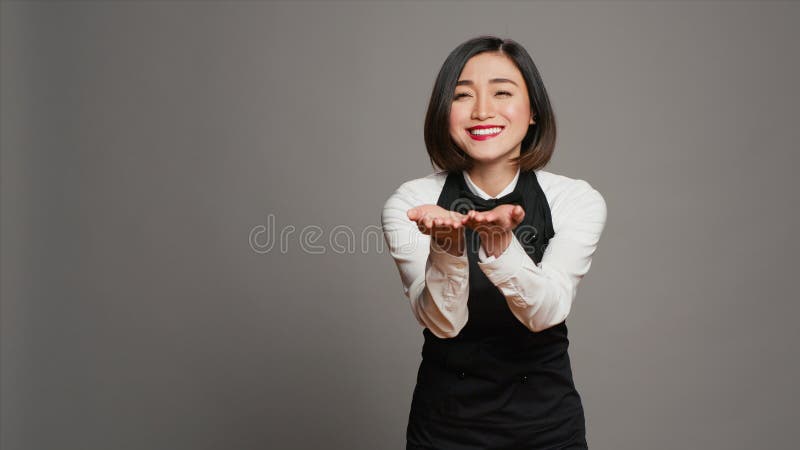 Cute Flirty Waitress Blowing Air Kisses In Front Of Camera Stock Image